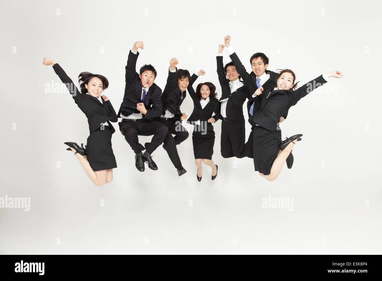 Japanese business people jumping Stock Photo - Alamy