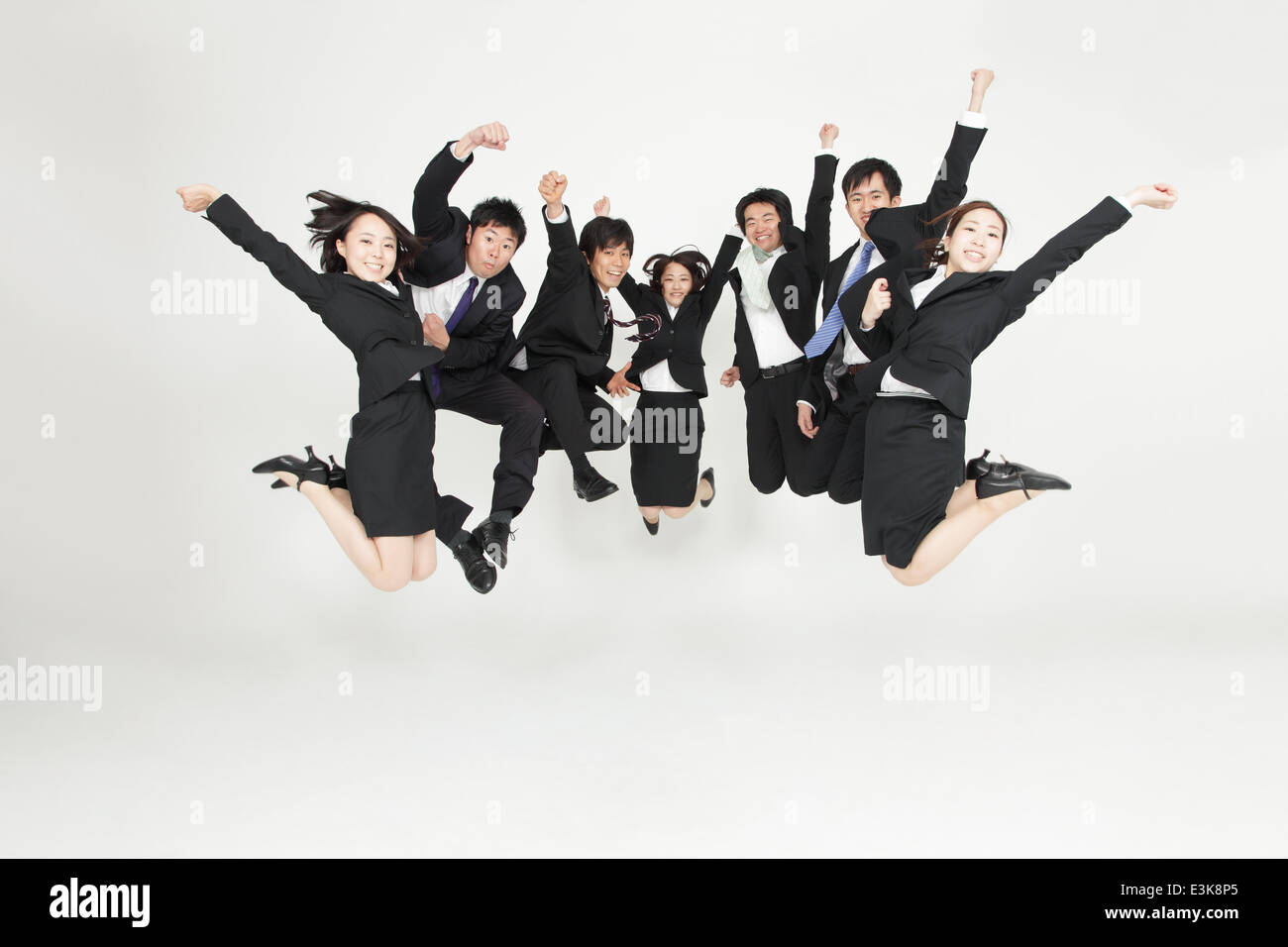 Japanese business people jumping Stock Photo - Alamy