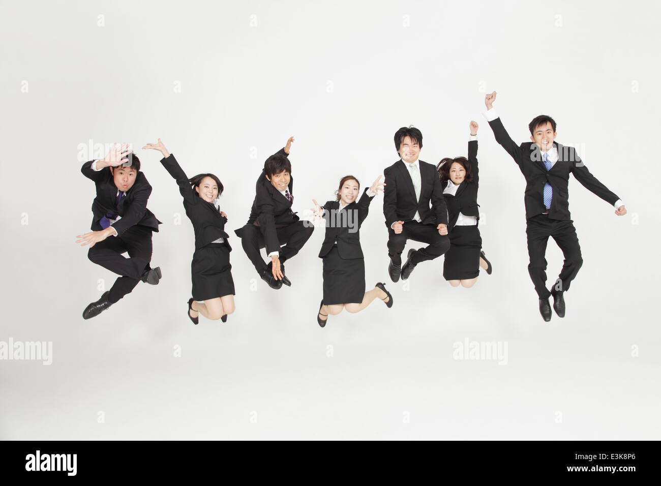 Japanese business people jumping Stock Photo - Alamy