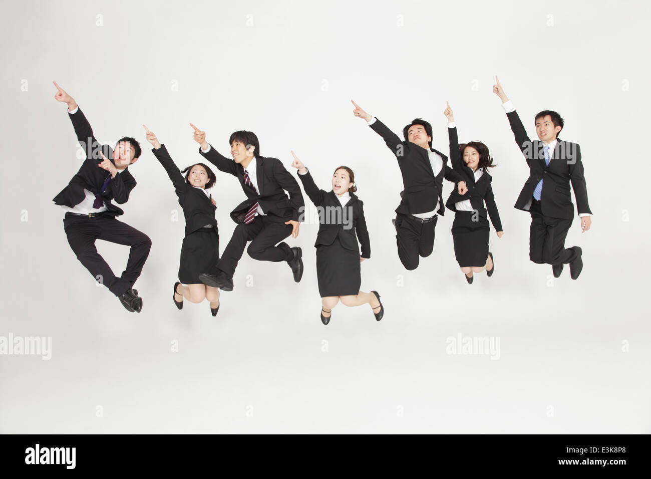 Japanese business people jumping Stock Photo - Alamy