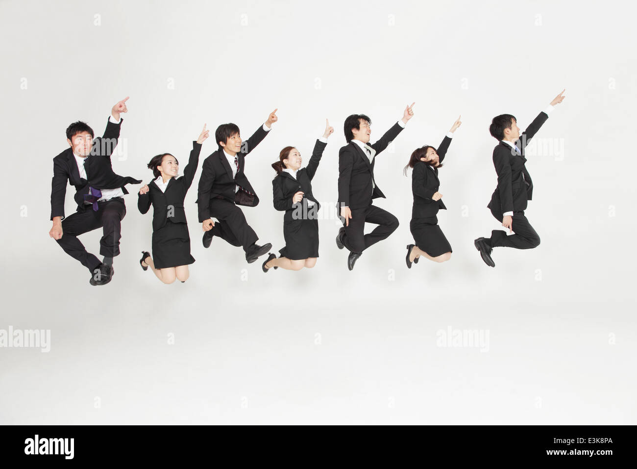 Japanese business people jumping Stock Photo - Alamy