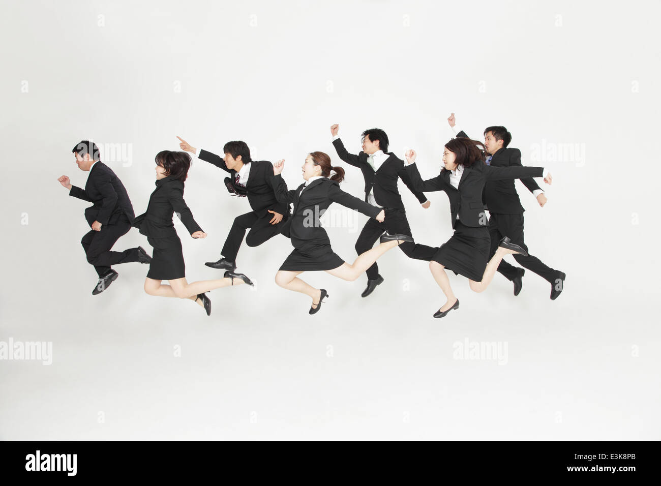 Japanese business people jumping Stock Photo - Alamy