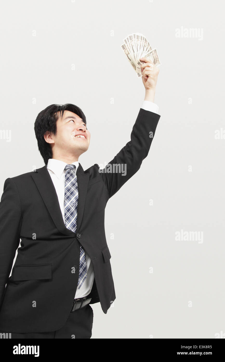 Japanese businessman with money Stock Photo - Alamy
