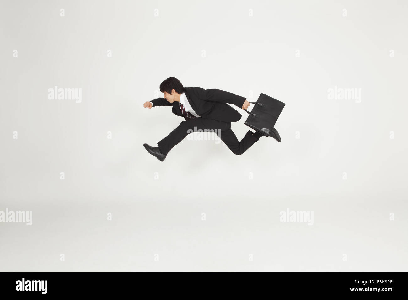 Japanese businessman running in mid-air Stock Photo - Alamy