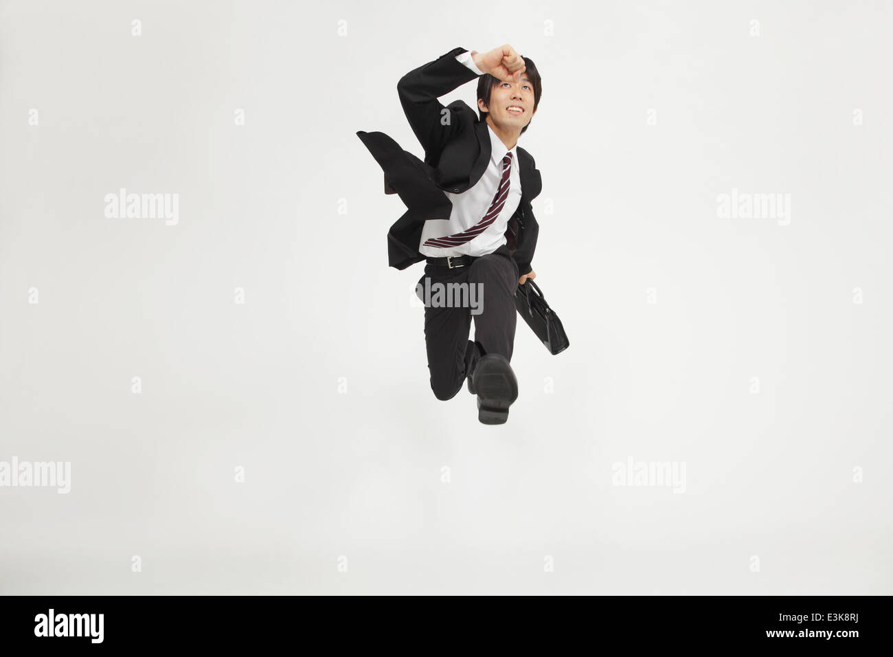 Japanese businessman running in mid-air Stock Photo - Alamy