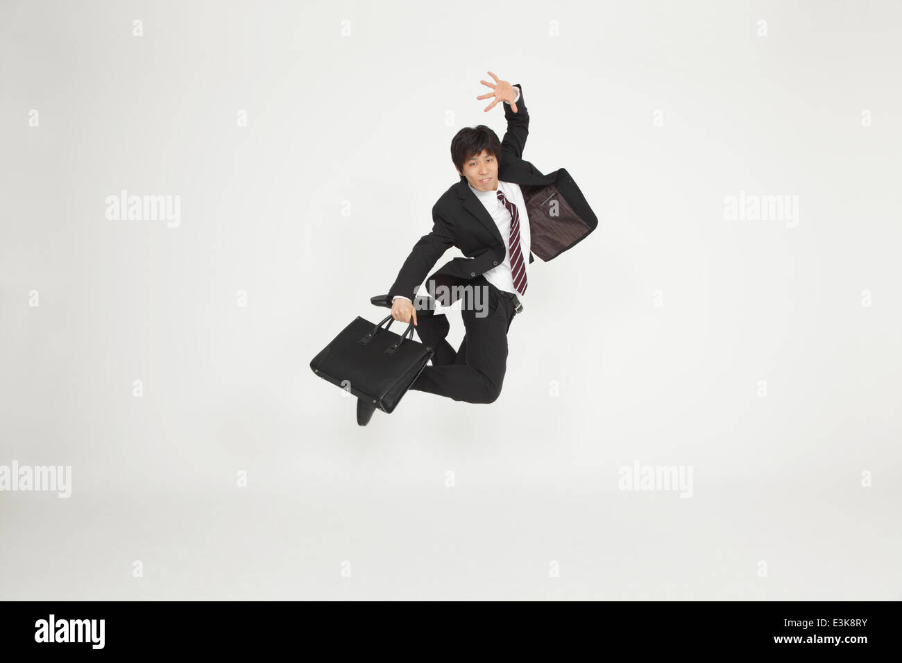 Japanese businessman jumping Stock Photo - Alamy