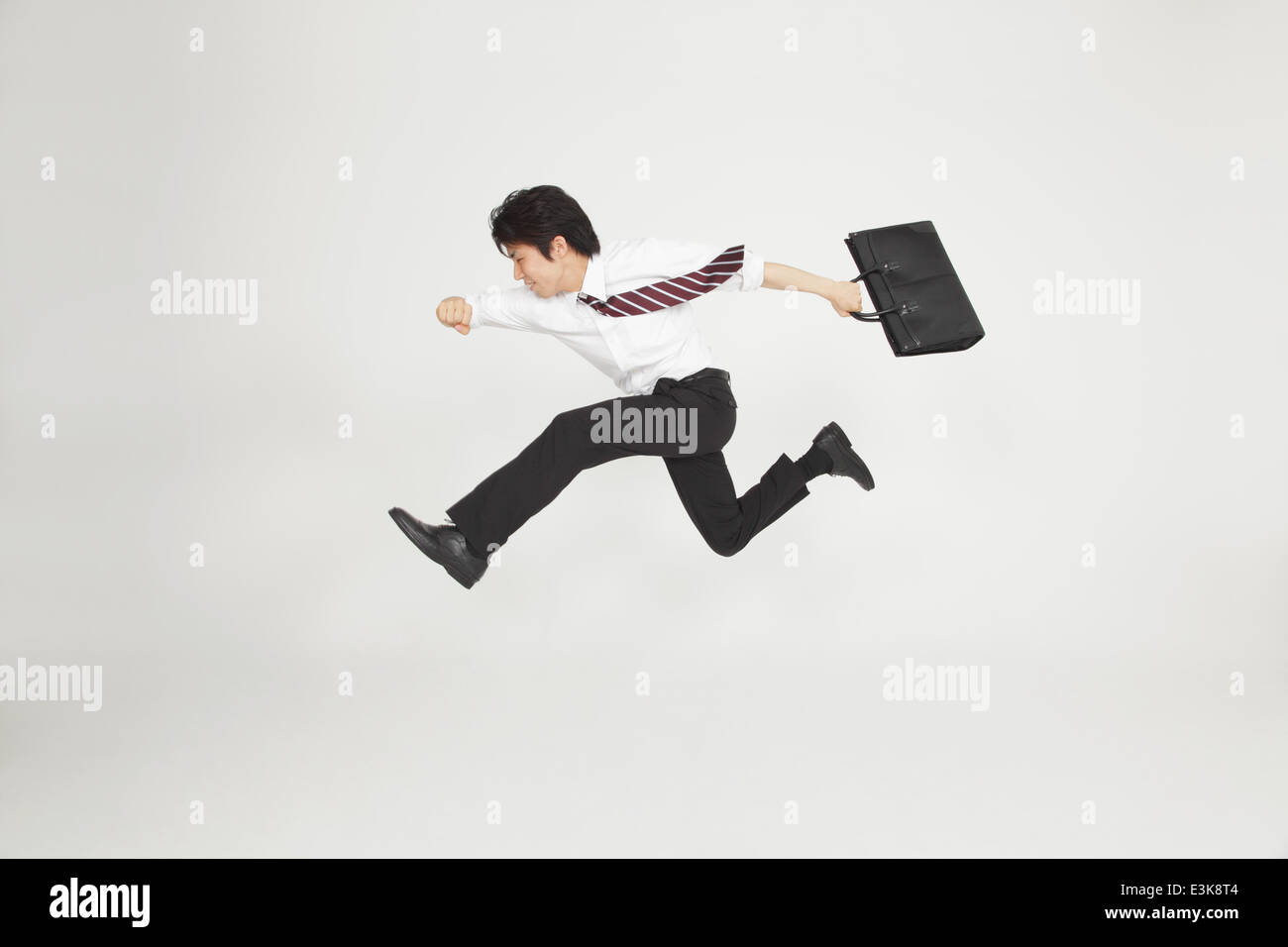 Japanese businessman running in mid-air Stock Photo - Alamy