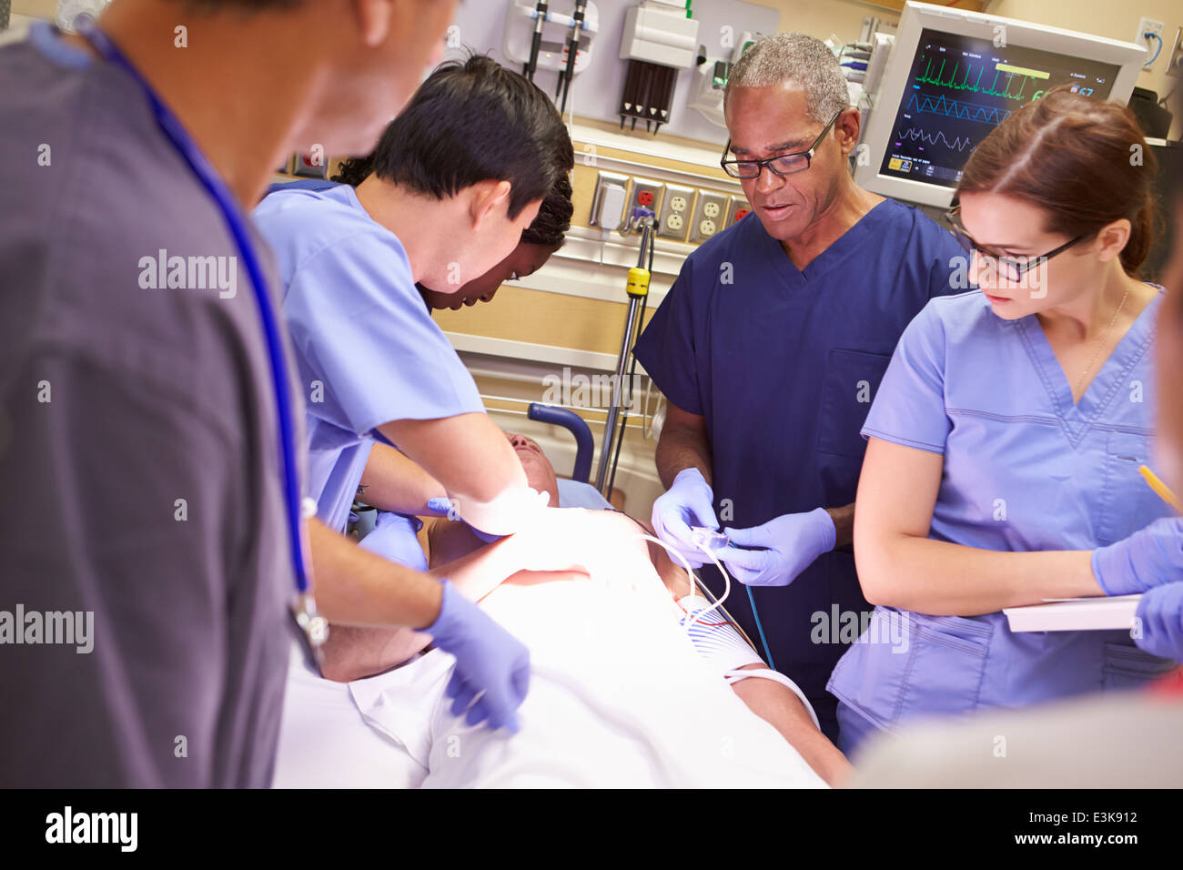 Medical Team Working On Patient In Emergency Room Stock Photo - Alamy