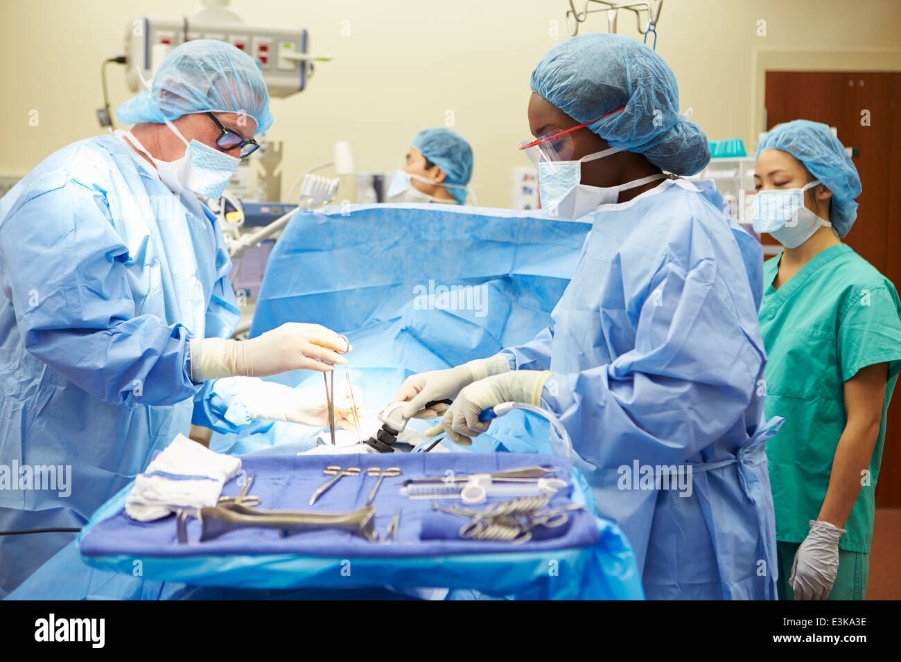Surgical Team Working In Operating Theatre Stock Photo - Alamy