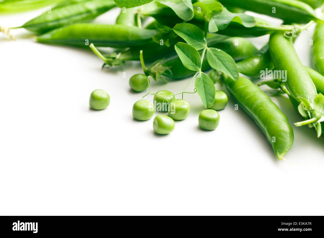 green pea pods on white background Stock Photo - Alamy