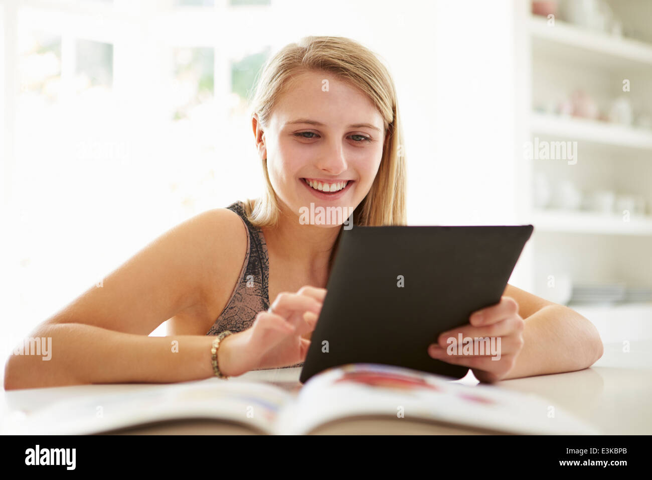 Teenage Girl Studying Using Digital Tablet At Home Stock Photo - Alamy