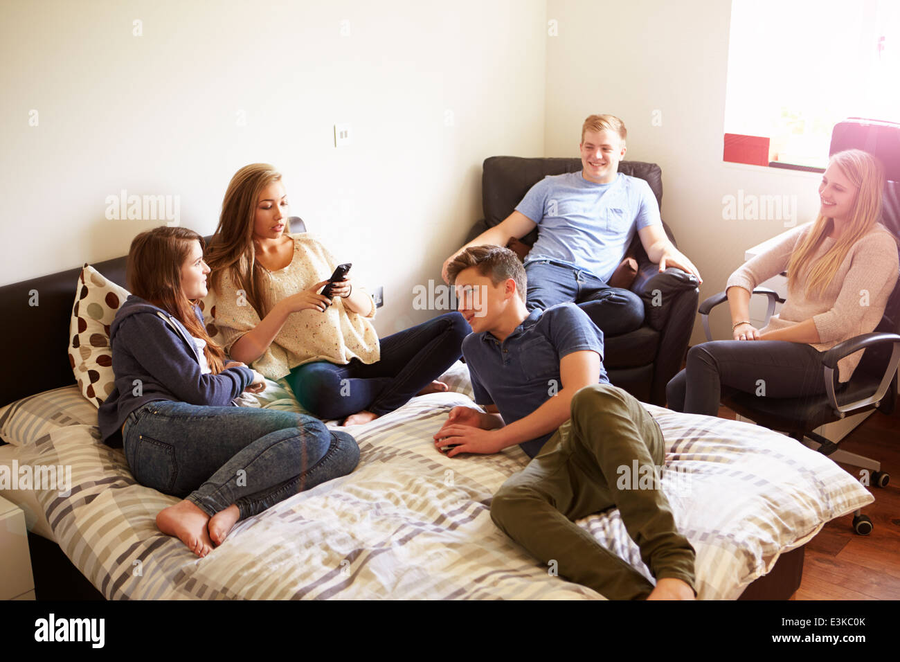Group Of Teenagers Relaxing In Bedroom Stock Photo - Alamy