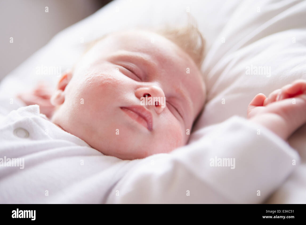 Newborn Baby Girl Sleeping In Bed Stock Photo - Alamy