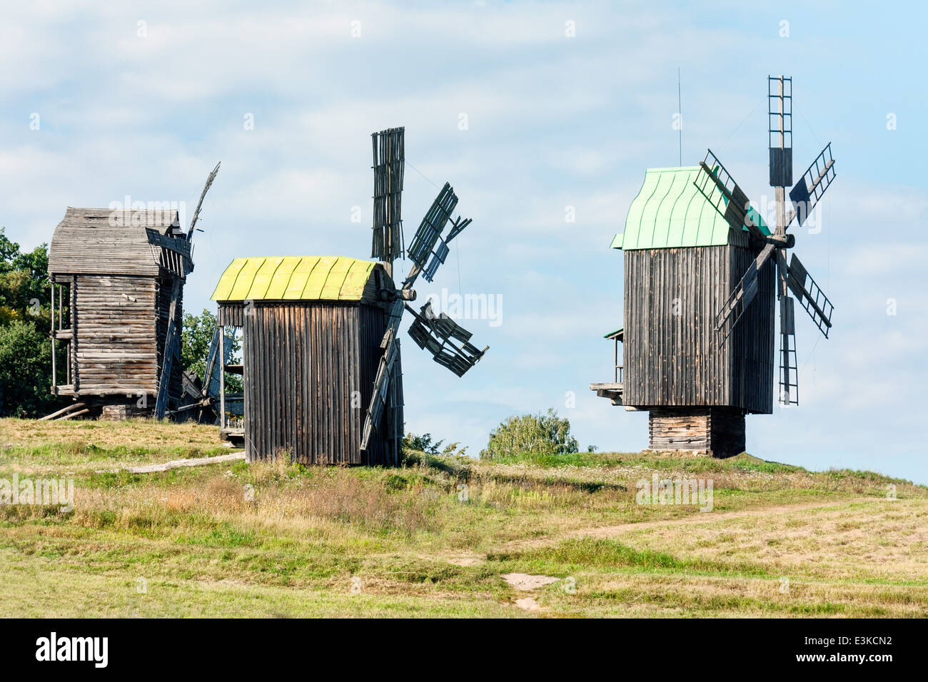 Old wooden traditional ukrainian windmill over blue sky with clouds ...