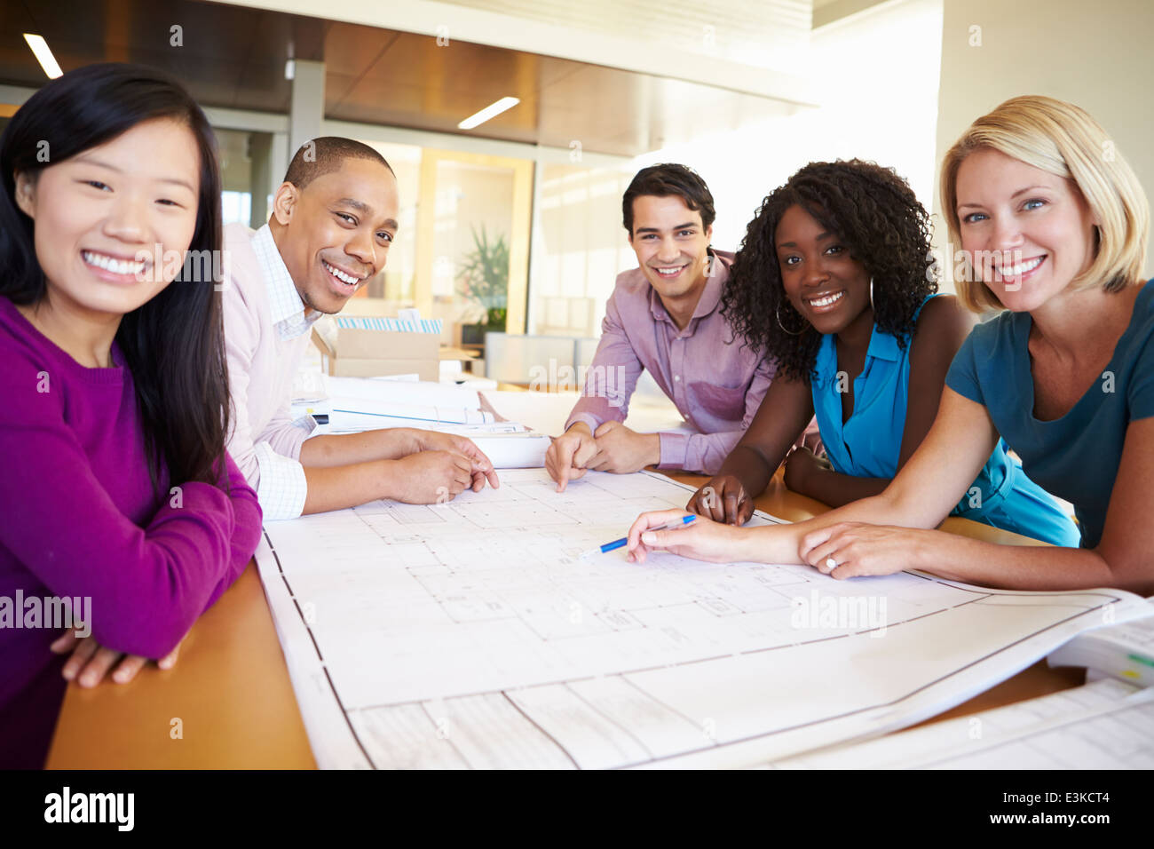 Group Of Architects Discussing Plans In Modern Office Stock Photo - Alamy