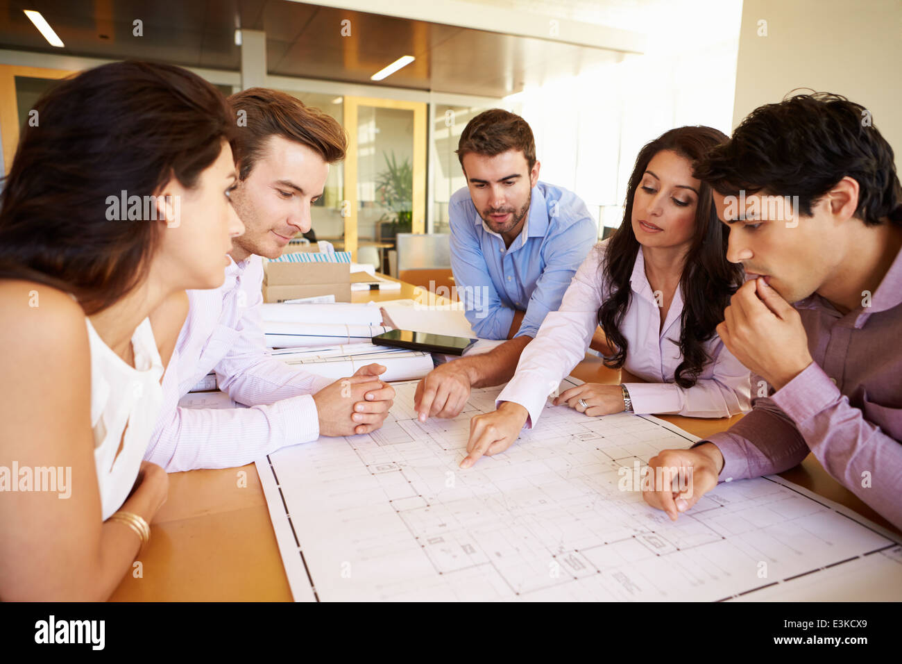 Group Of Architects Discussing Plans In Modern Office Stock Photo - Alamy