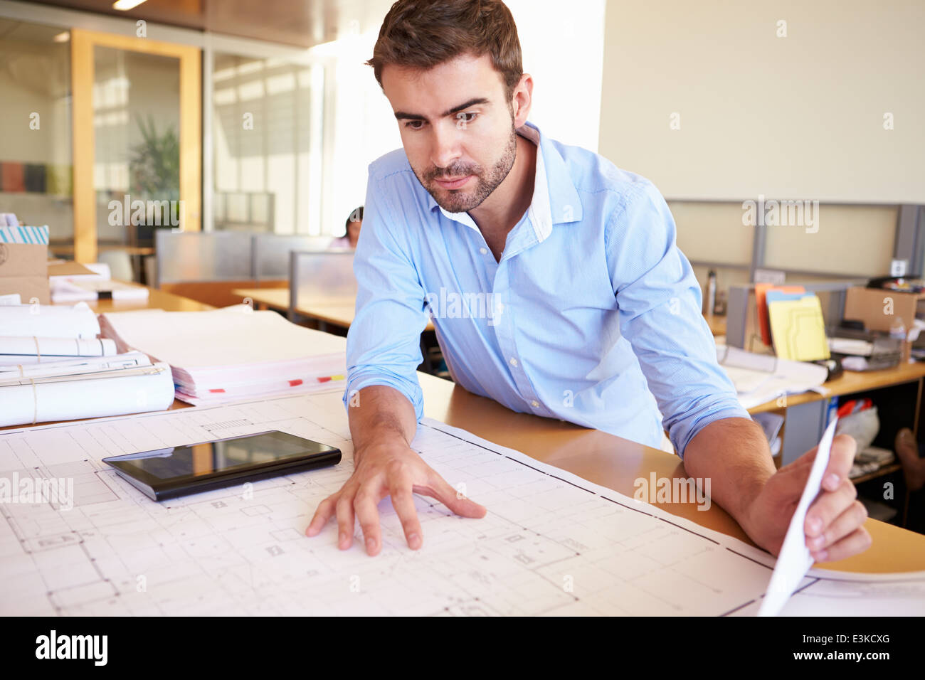 Male Architect With Digital Tablet Studying Plans In Office Stock Photo ... Male Architect With Digital Tablet Studying Plans In Office Stock Photo ...