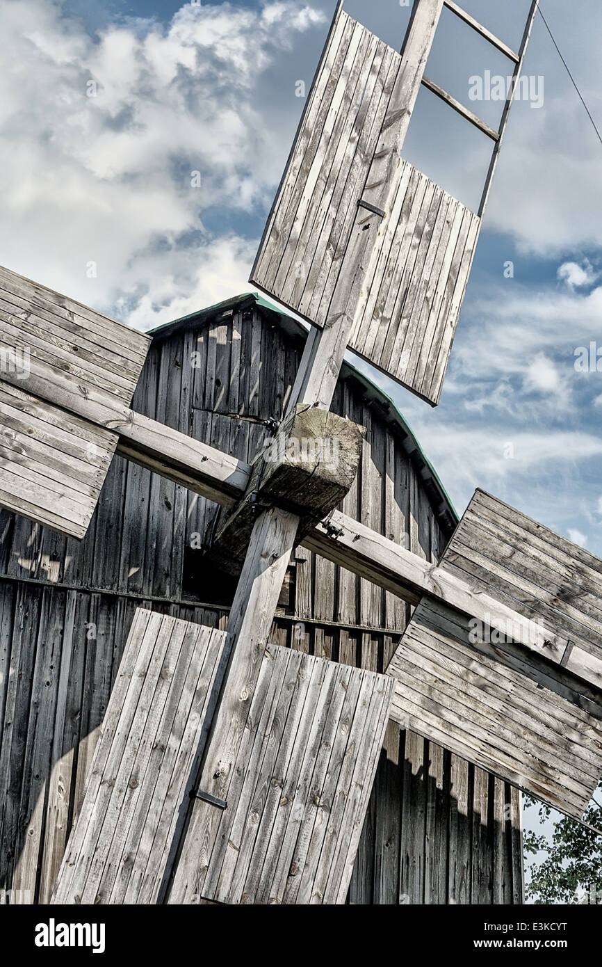 Old wooden traditional ukrainian windmill over blue sky with clouds ...