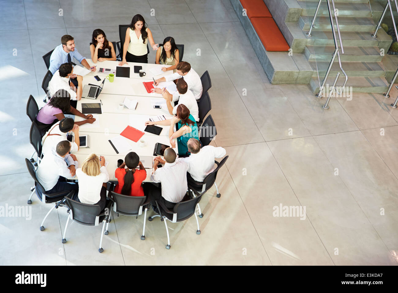 Businesswoman Addressing Meeting Around Boardroom Table Stock Photo - Alamy