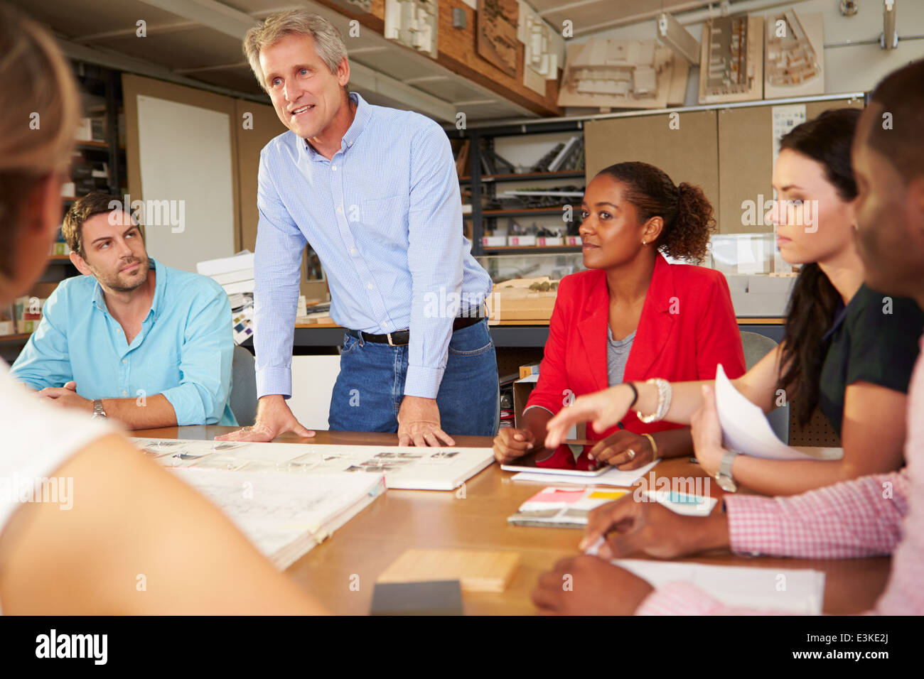 Male Boss Leading Meeting Of Architects Sitting At Table Stock Photo ...