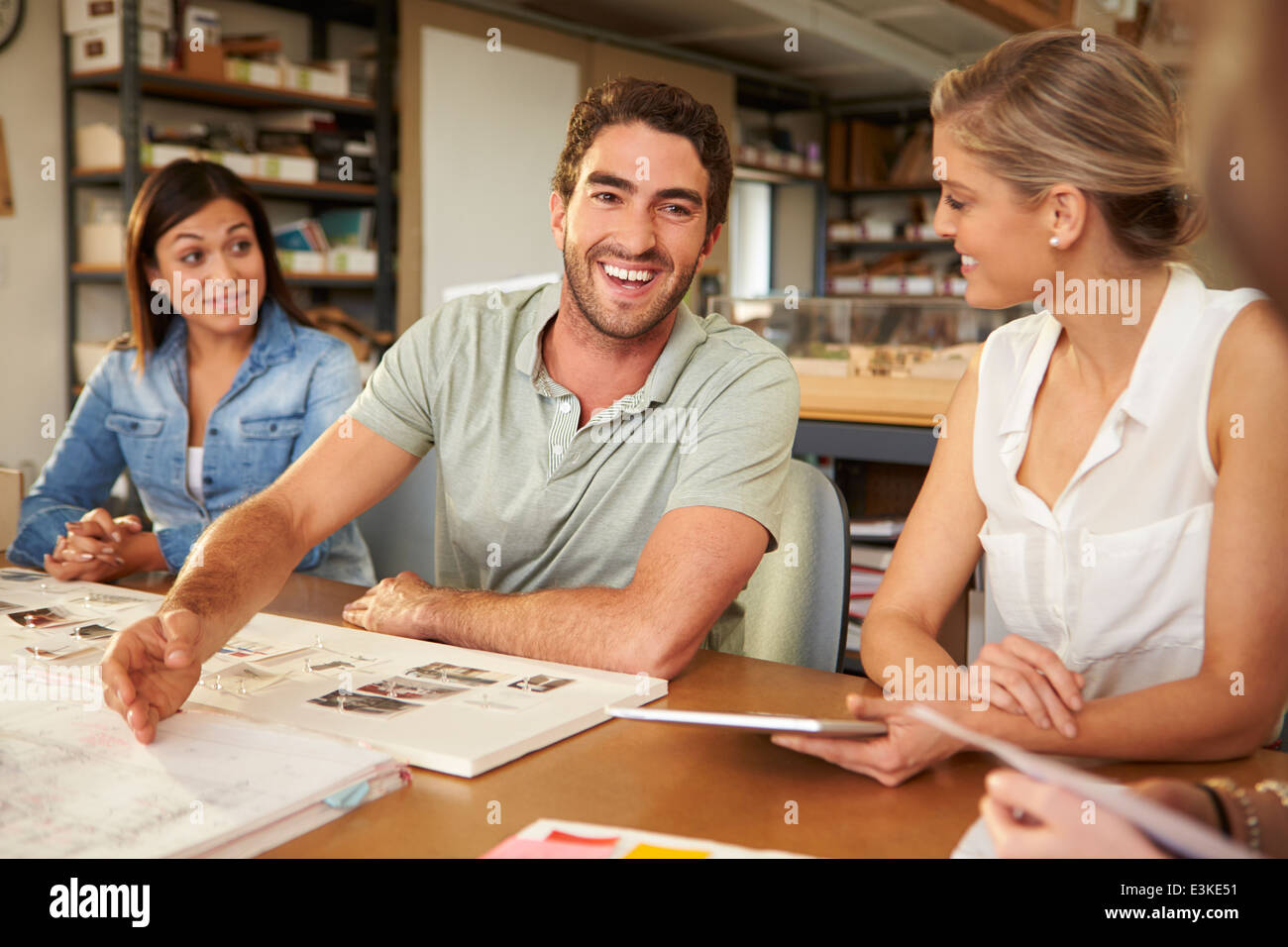 Four Architects Sitting Around Table Having Meeting Stock Photo - Alamy