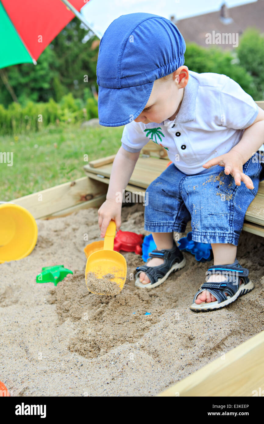 little male child playing in the sandbox Stock Photo - Alamy