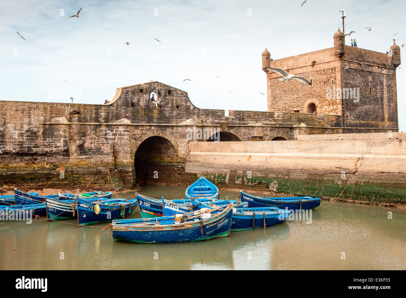 Traditional, blue painted fishing boats in the harbour below the Sqala ...