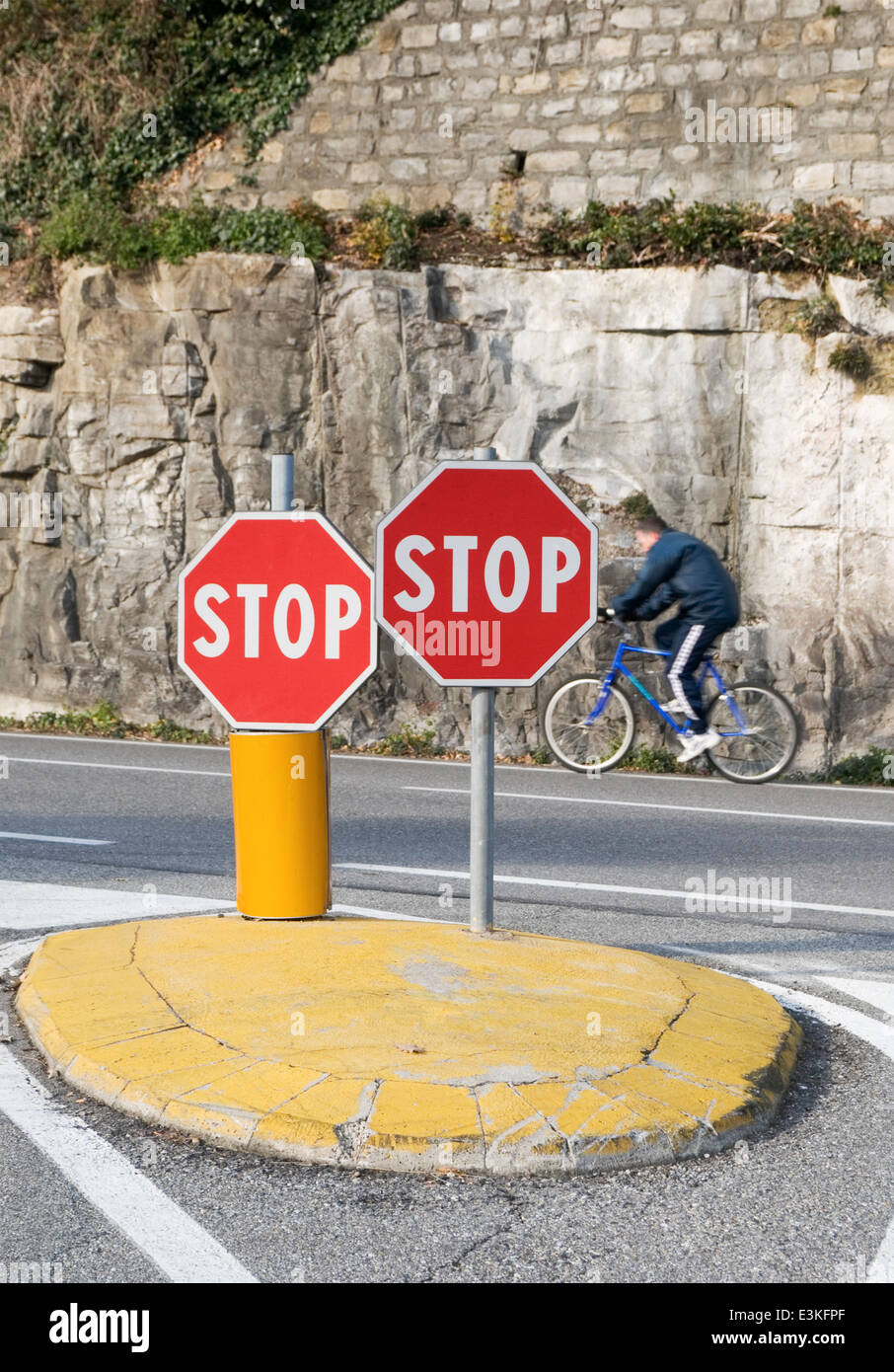 Stop signs and cyclist Stock Photo - Alamy