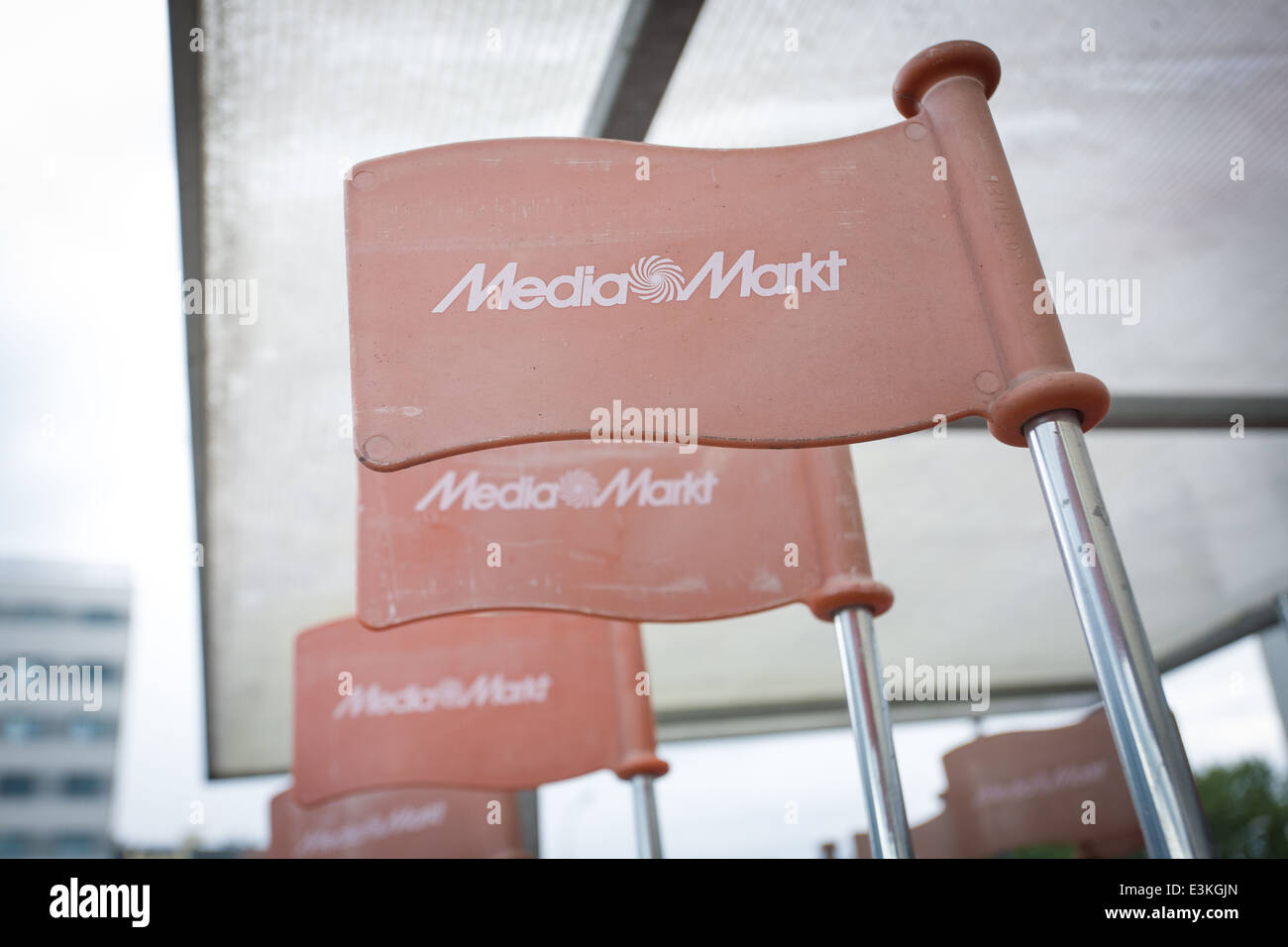 Flags on top of trolleys at the Media Markt are seen Stock Photo - Alamy