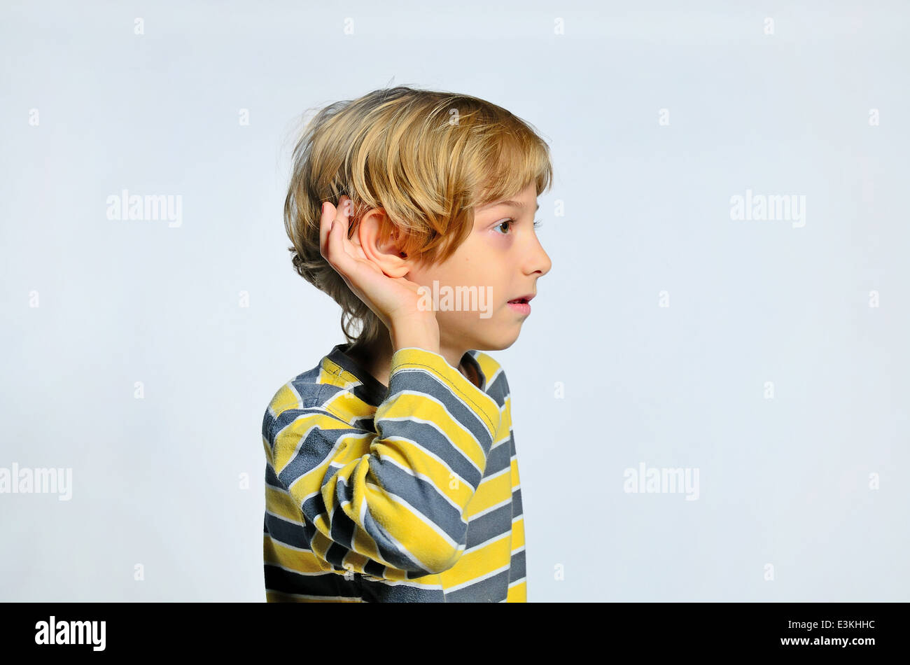 Young boy hear on gray background Stock Photo - Alamy