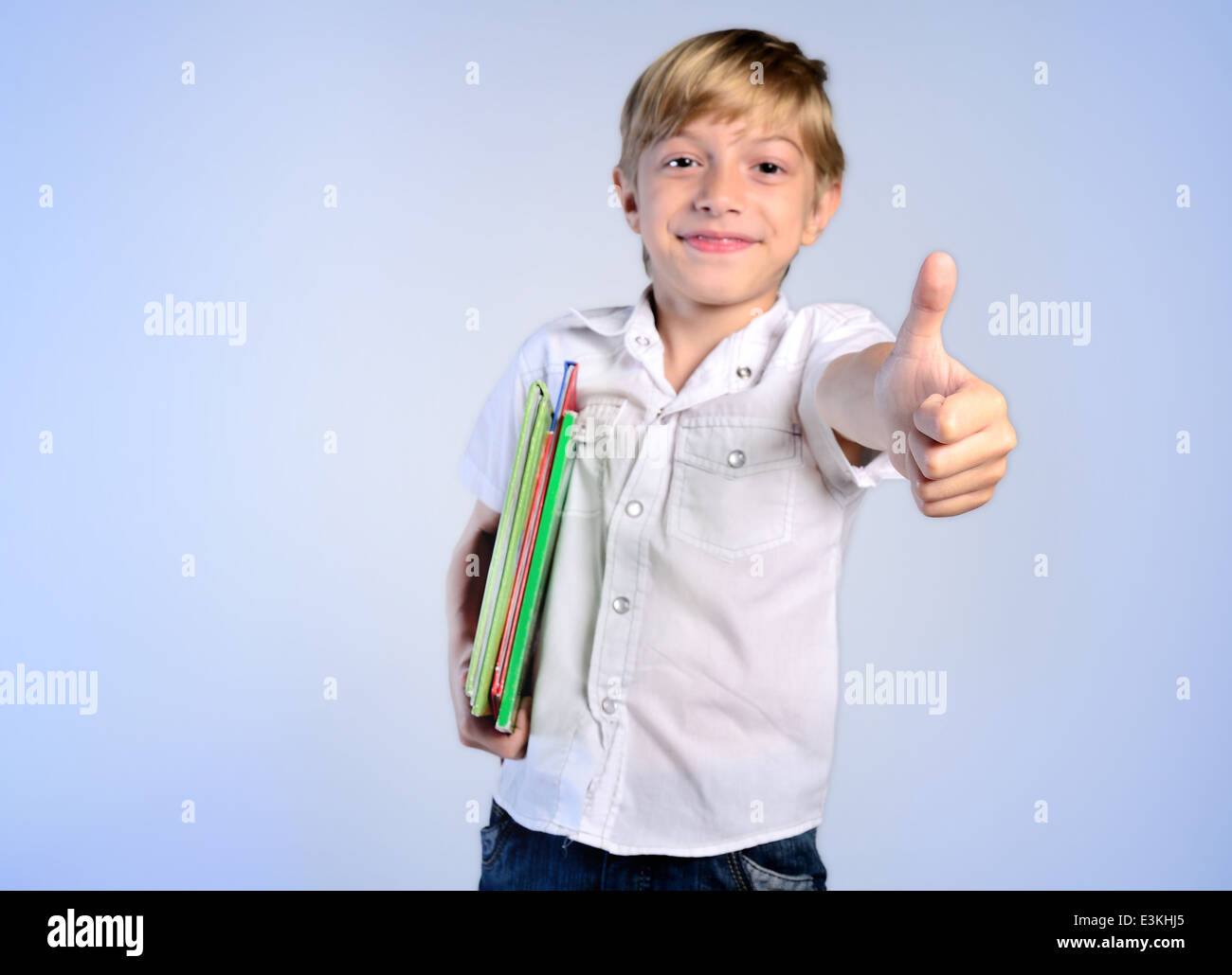Young boy agree on blue background Stock Photo - Alamy