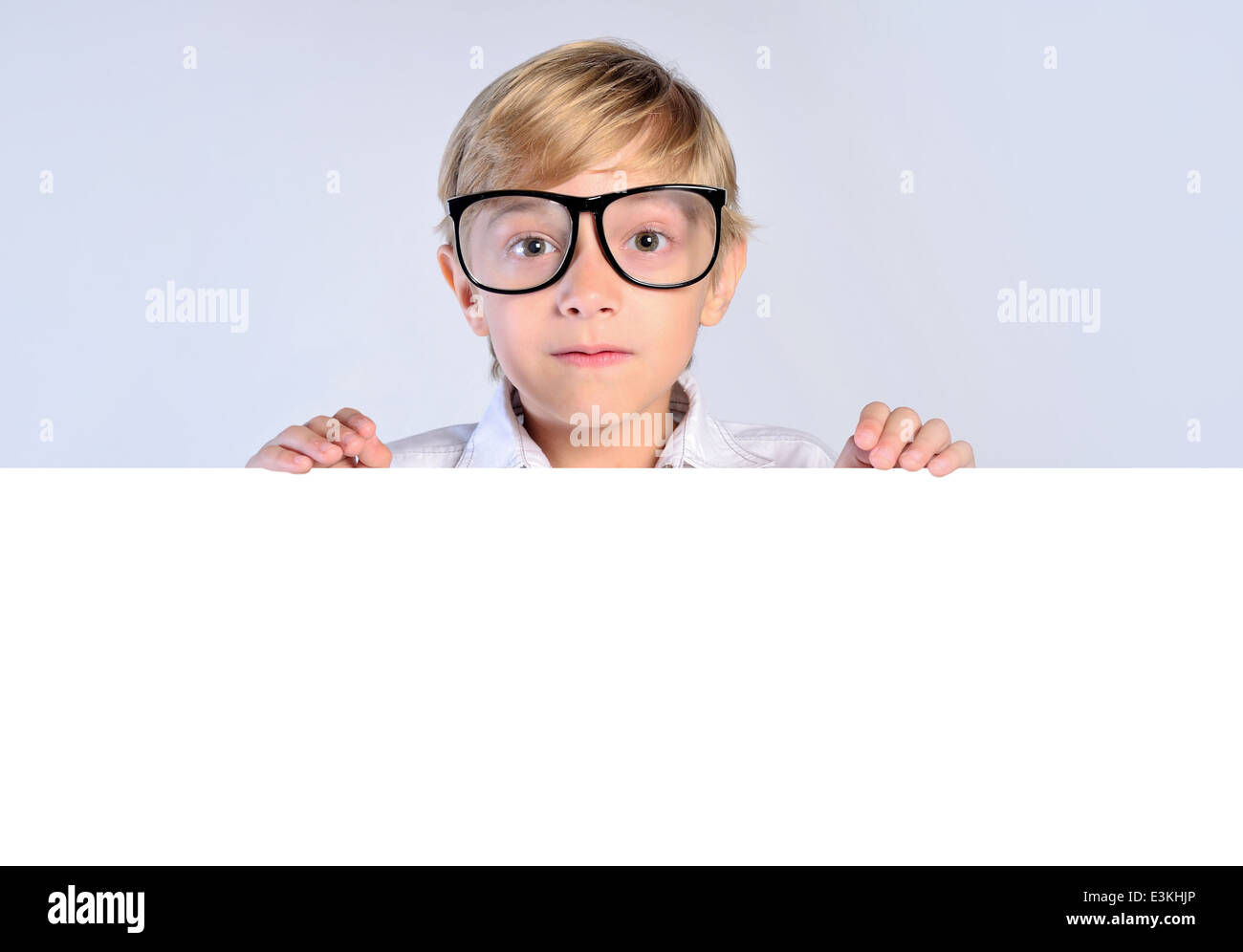Young nerd boy leaning on blank banner Stock Photo - Alamy