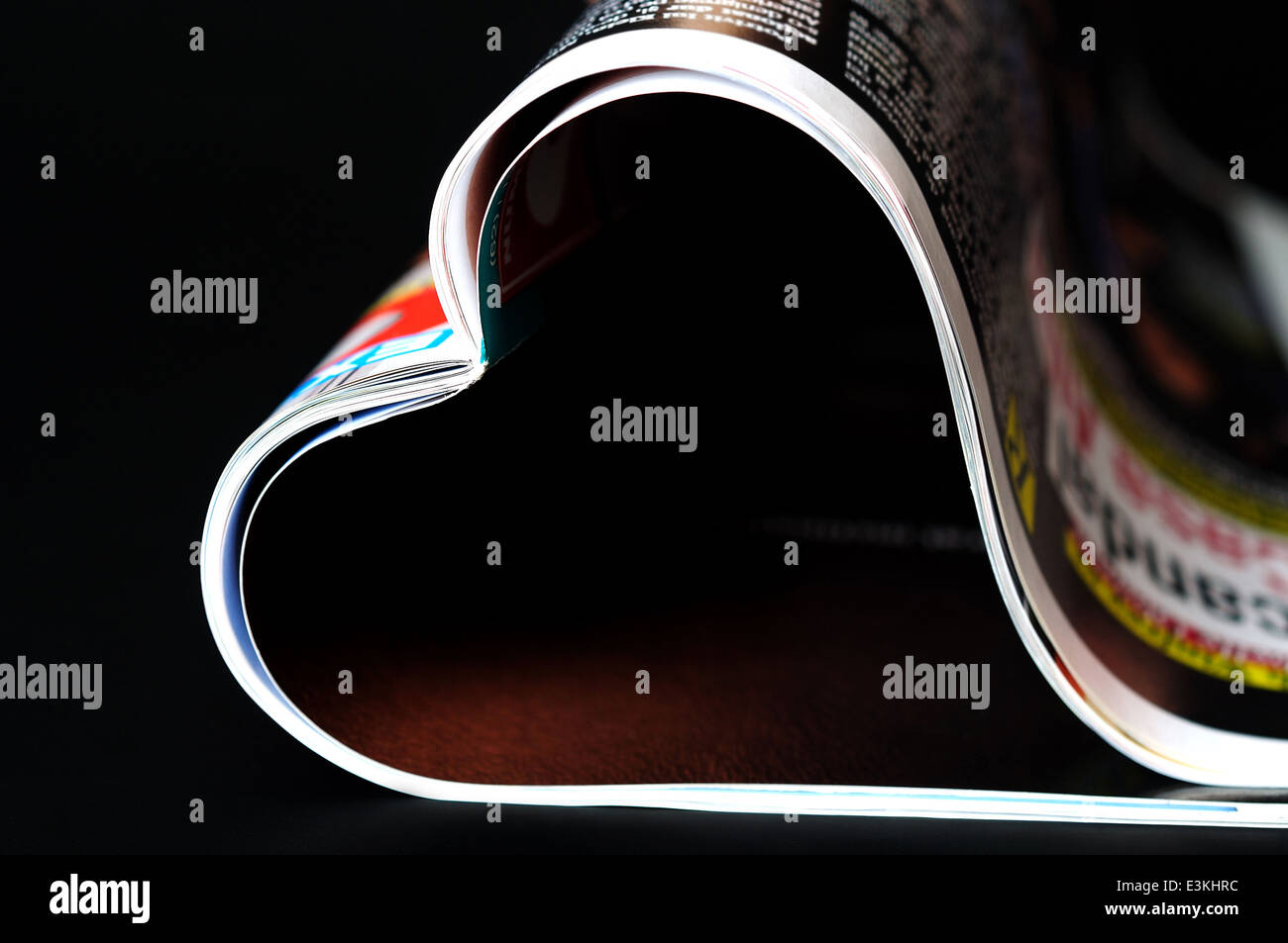 Magazine in heart shape on black Stock Photo - Alamy