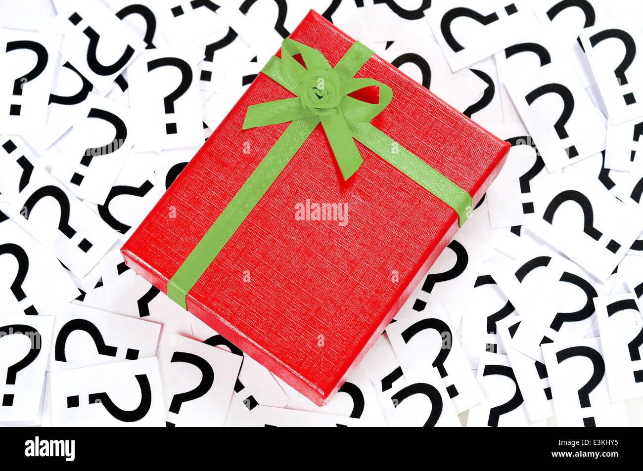 Gift box on question mark background Stock Photo - Alamy