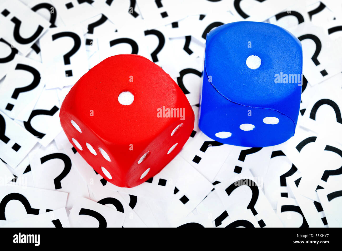 Dice on question mark background Stock Photo - Alamy