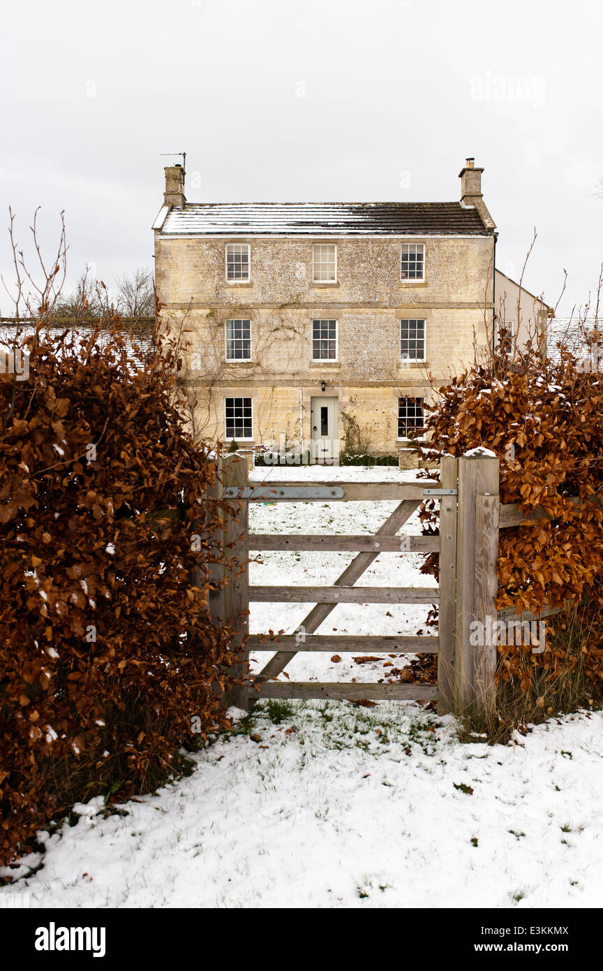 Exterior facade of a Georgian farmhouse seen from a snowy garden Stock ...