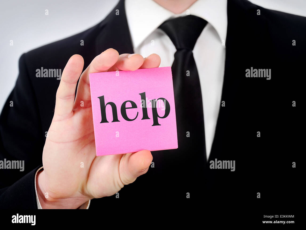 Business man showing help word Stock Photo - Alamy