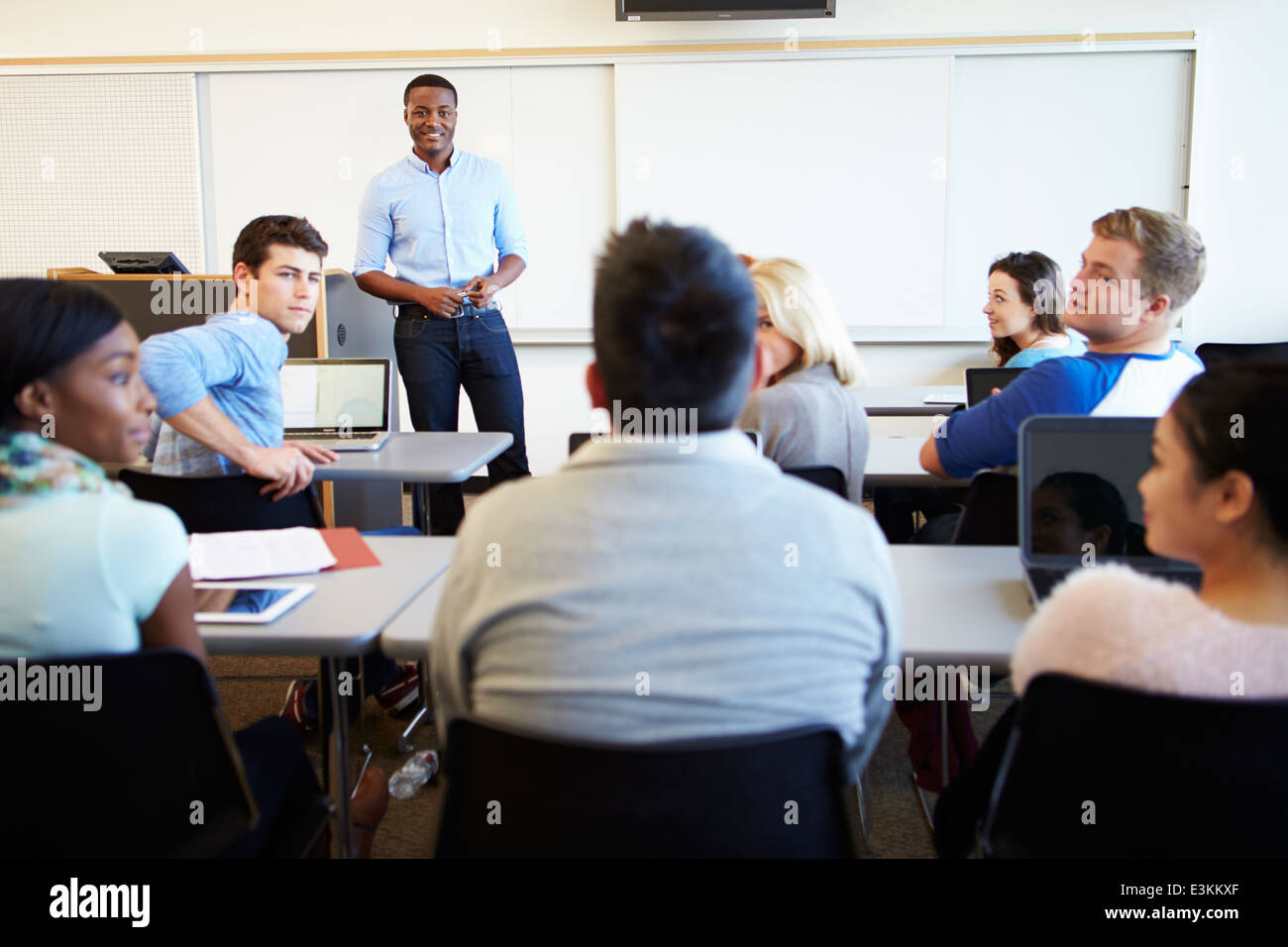 Male Tutor Teaching University Students In Classroom Stock Photo - Alamy