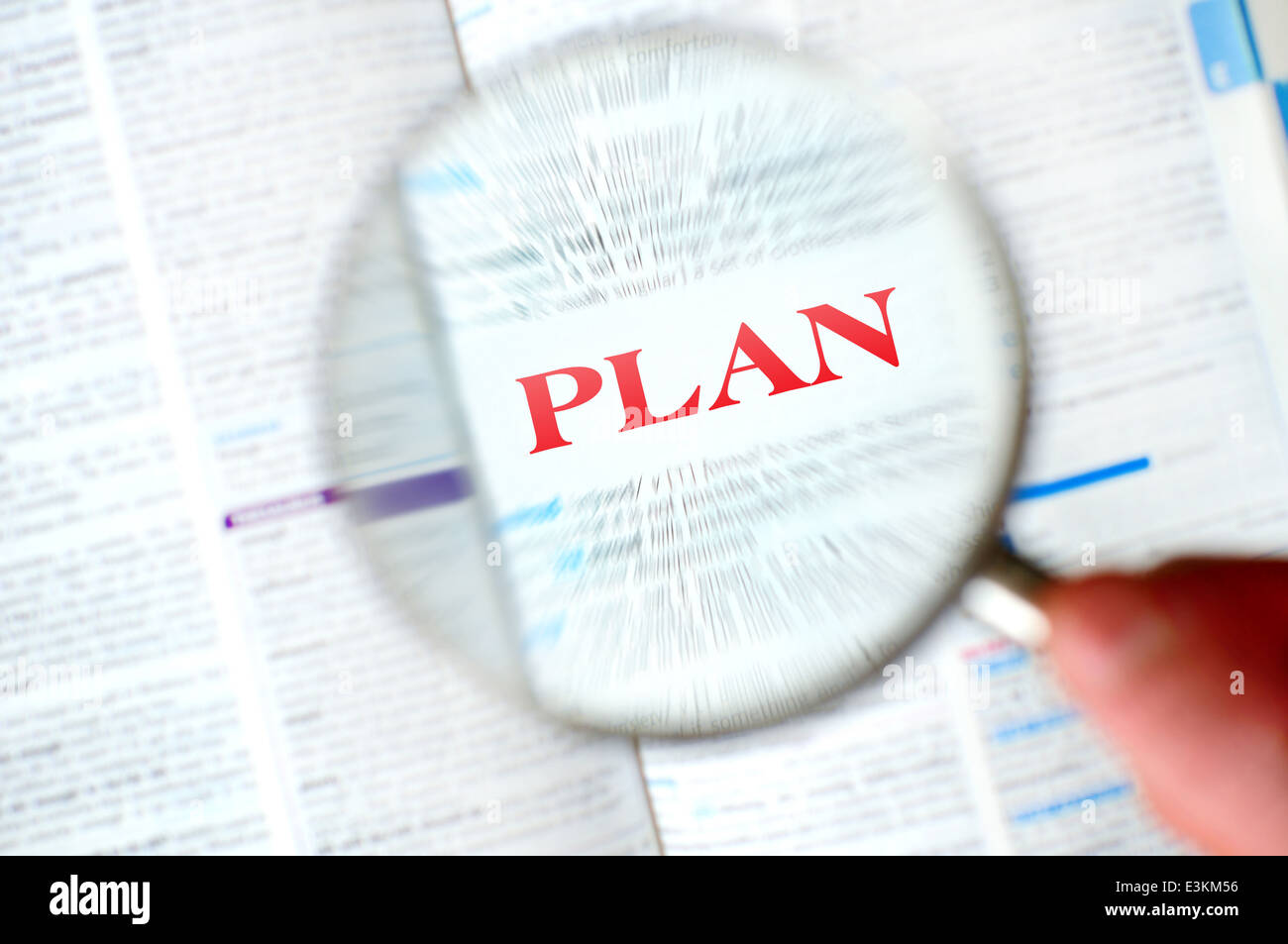 Magnifying plan word from book Stock Photo - Alamy
