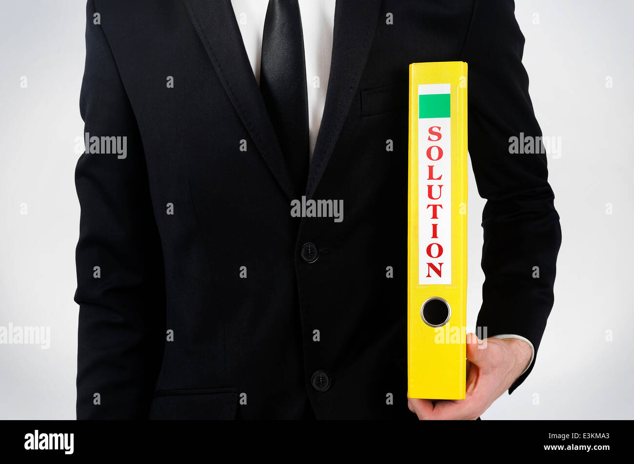 Business man holding folder with solution Stock Photo - Alamy