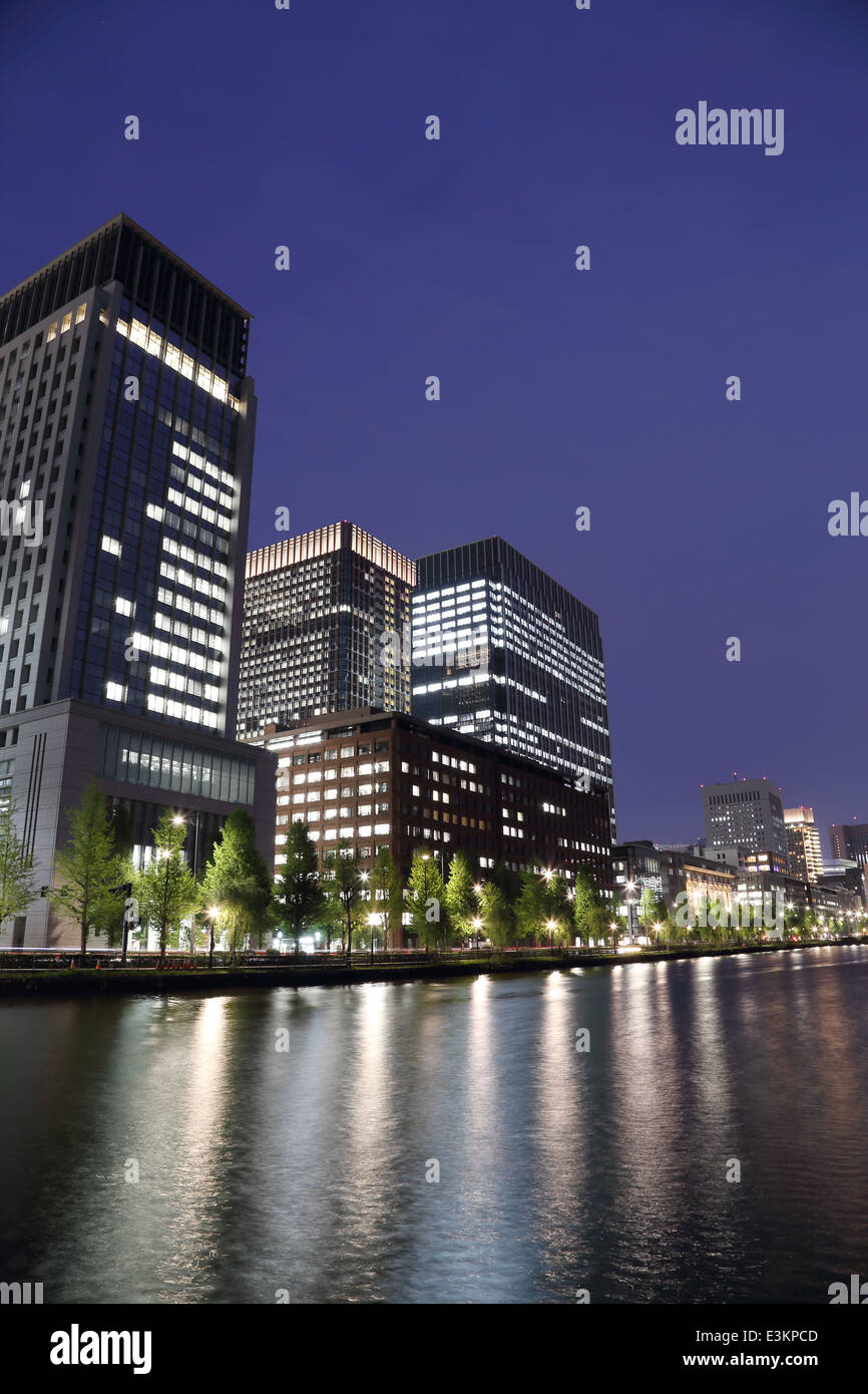 The city lights of Tokyo reflect off of the water, Japan Stock Photo ...