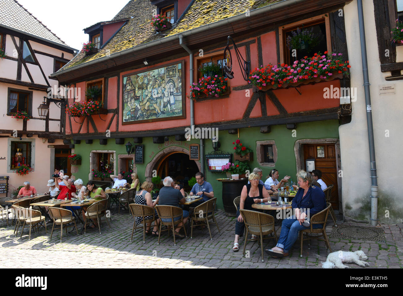 People eating outside The Medieval Restaurant in Riquewihr Alsace ...