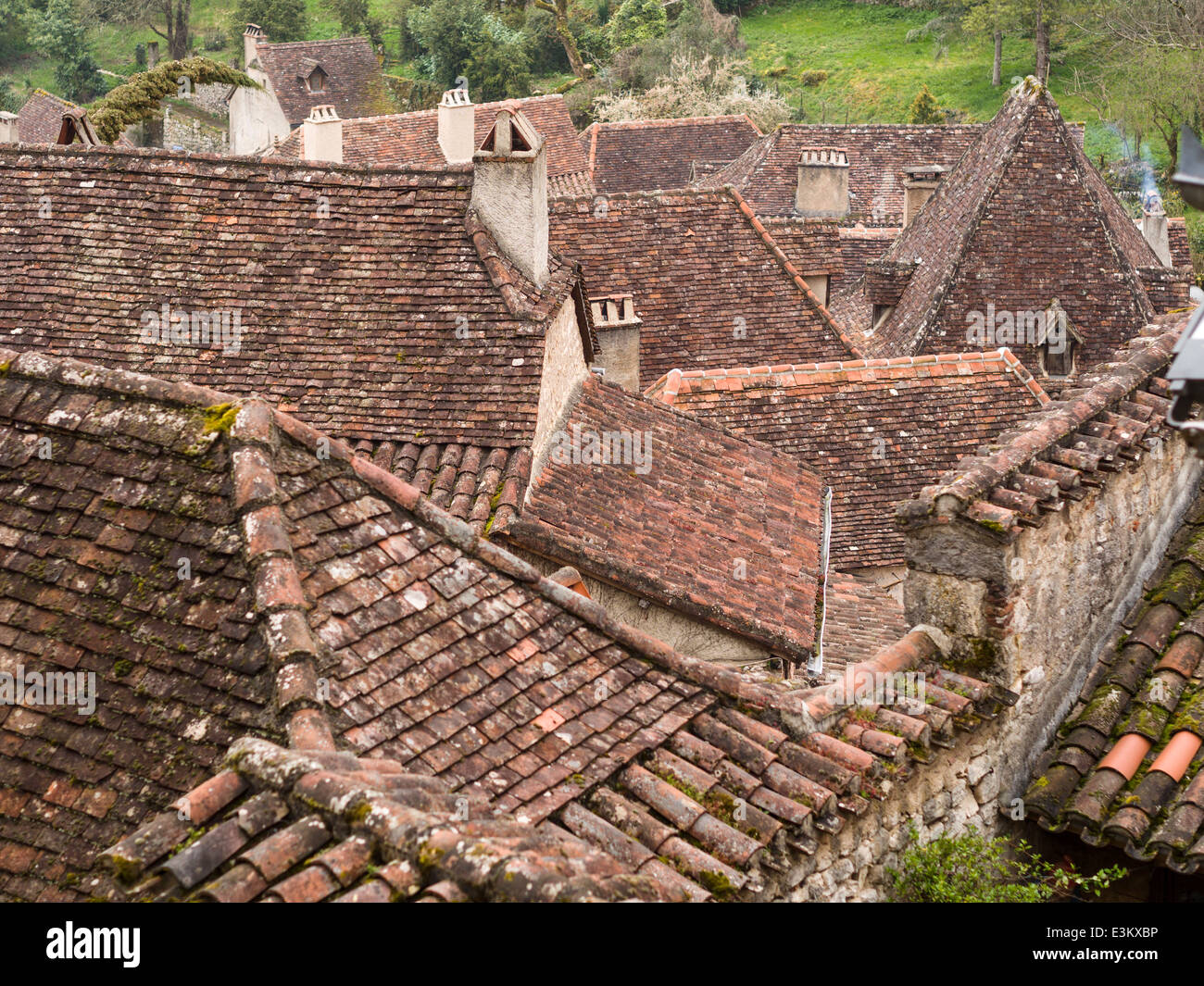 Roof tops and chimneys: houses in Lapopie. Overlapping roof lines and a ...