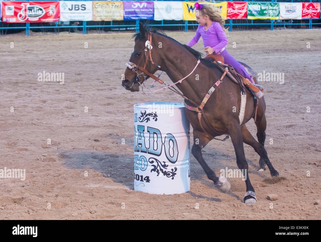 Cowgirl Participating in a Barrel racing competition at the Helldorado ...