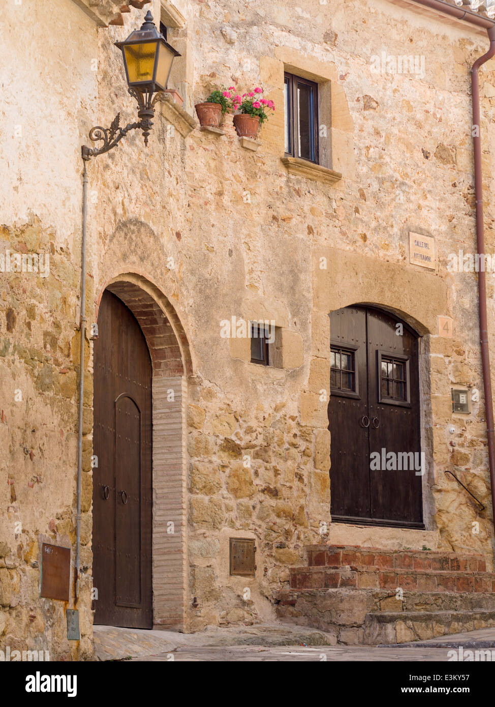 Pals stone house: Warm stone with Pots of geraniums. The warm stone ...