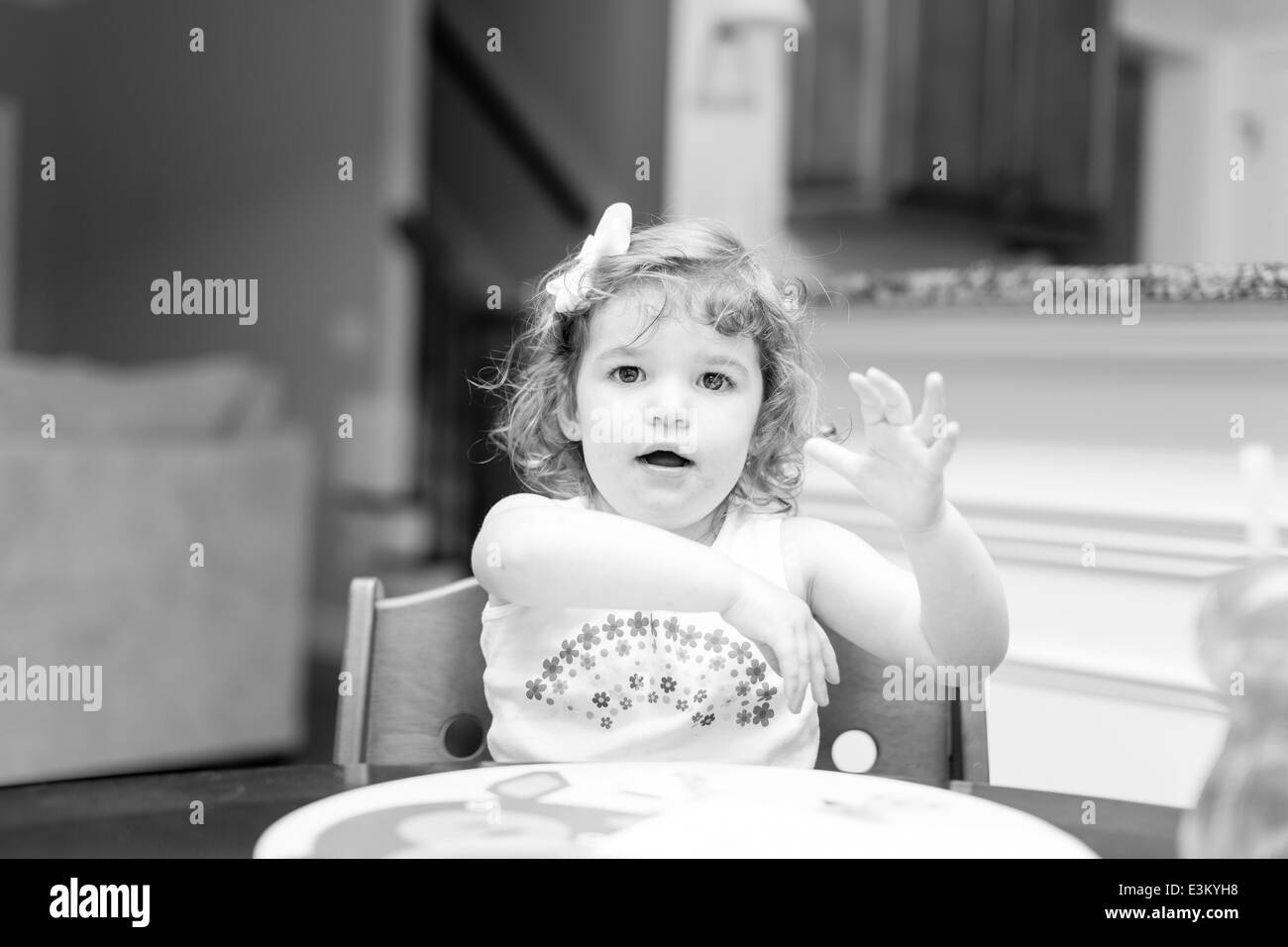 Little girl at dinner time making facial expressions Stock Photo - Alamy