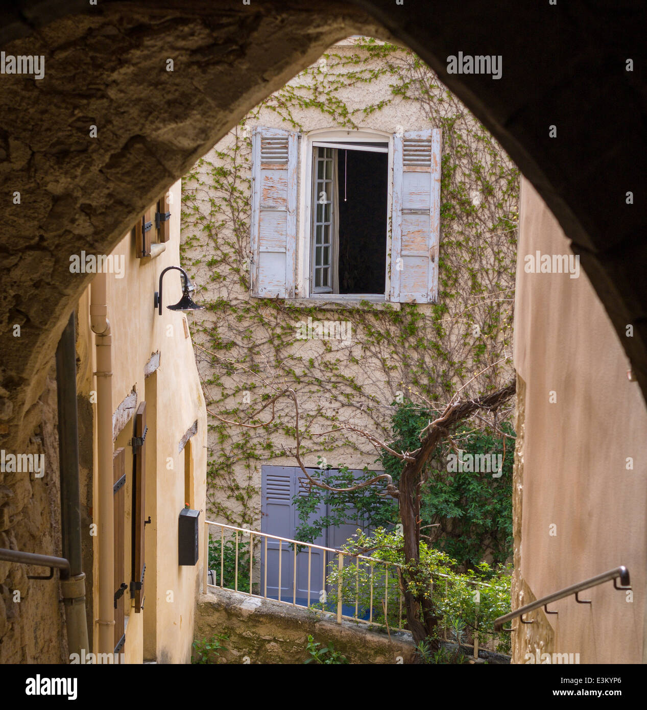 Hidden Window, Peeling blue shutters. Down an arched passage is a blue ...