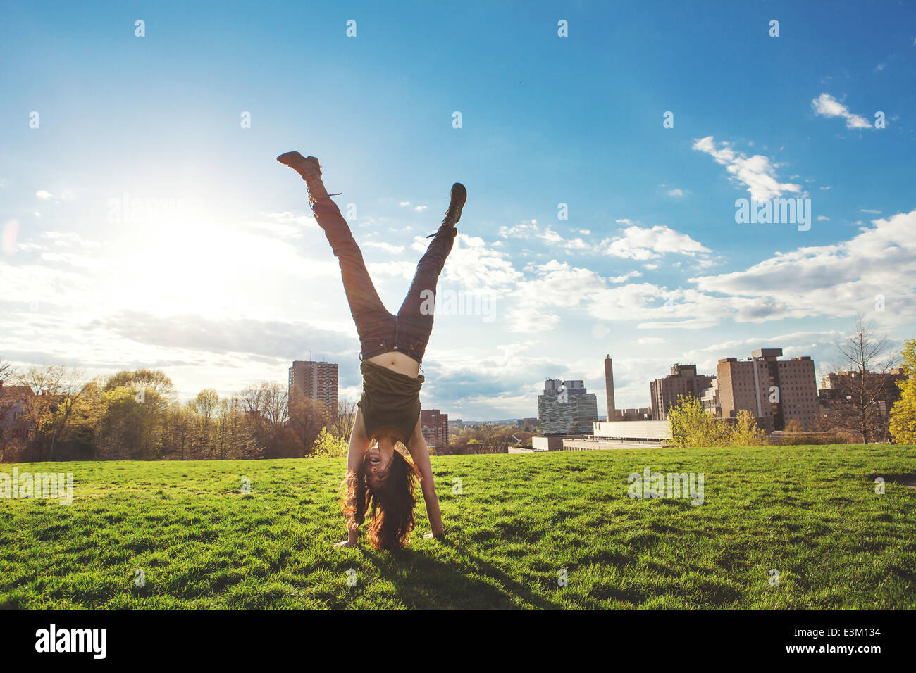 Young woman doing cartwheel Stock Photo - Alamy