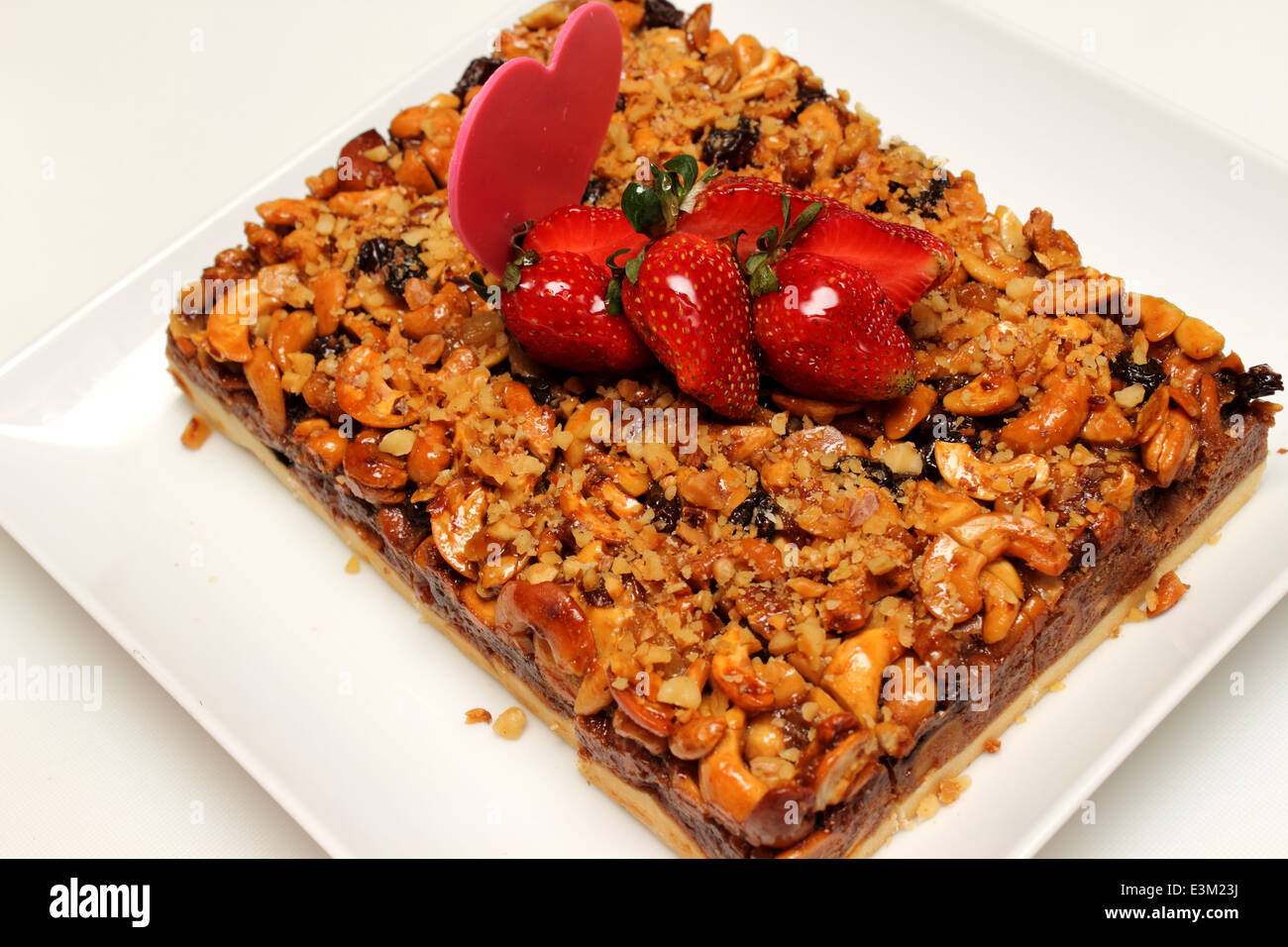 A Mixed nuts pie decorated with strawberry Stock Photo - Alamy