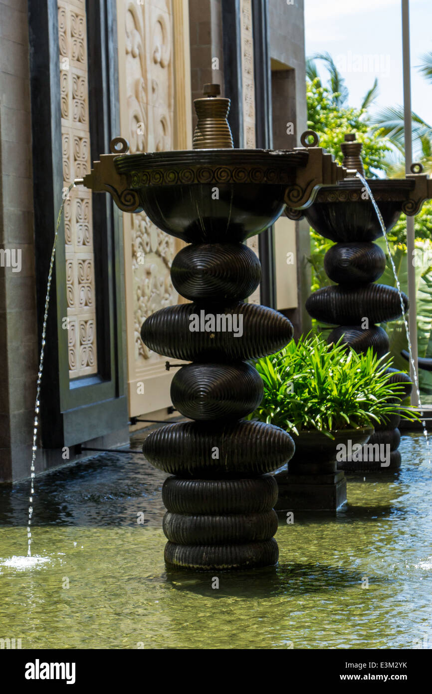 Ornamental fountain in a shallow pond in a landscaped garden outside a ...